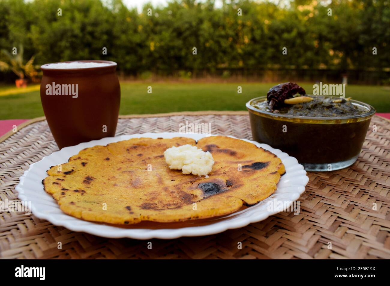 Side view of makki di roti and Sarson da saag, mustard leaves curry and ...