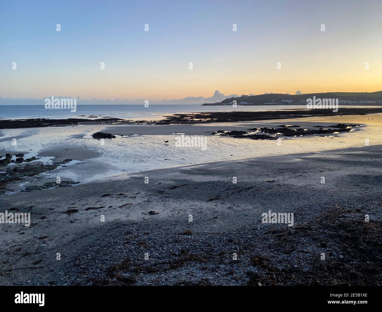 Sunset reflections on the sand at the beach at Douglas, Isle of Man ...