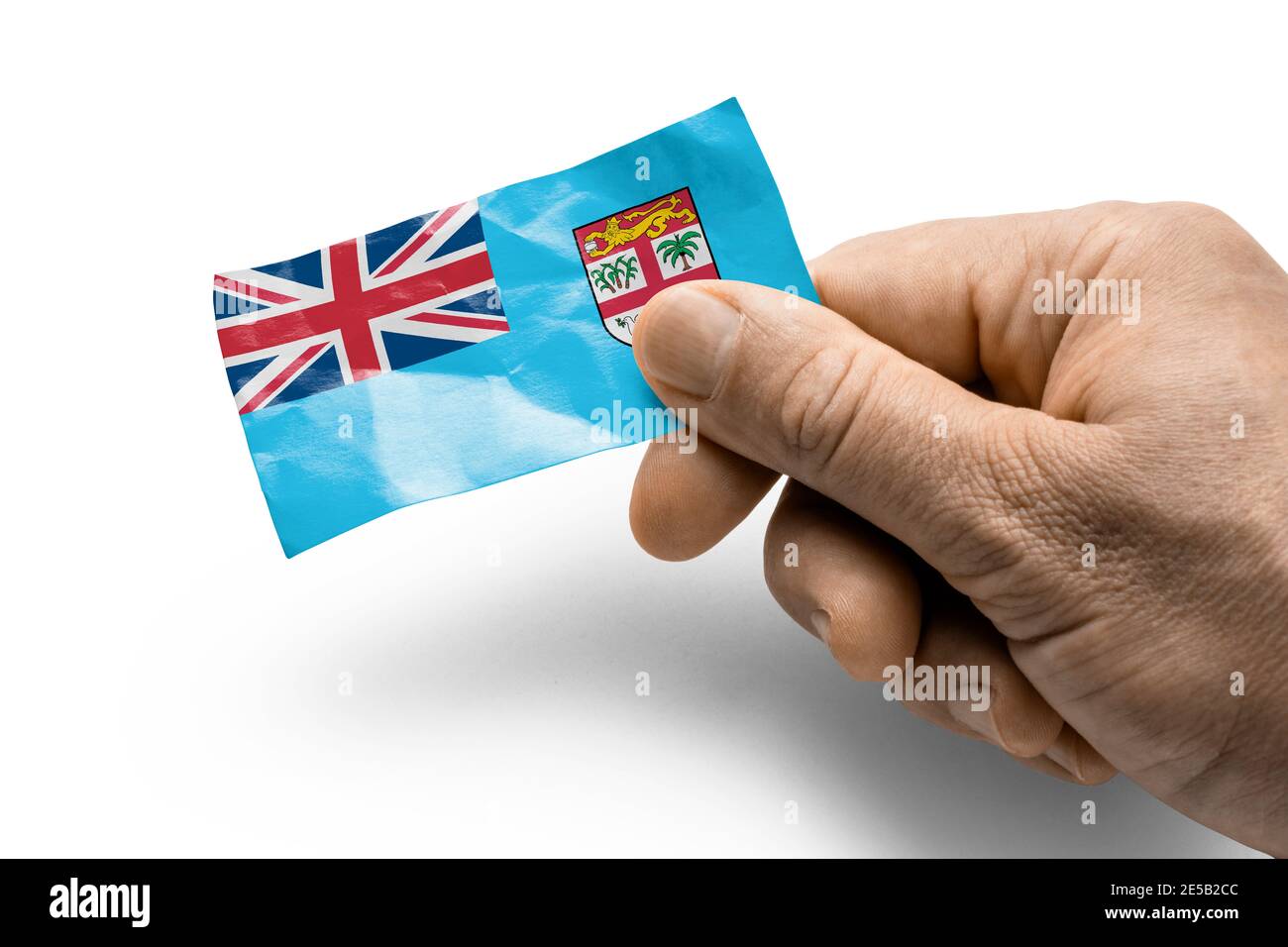 Hand holding a card with a national flag the Fiji Stock Photo - Alamy
