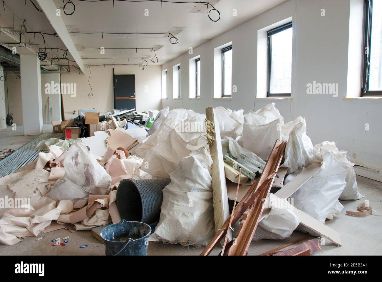 Messy construction site. Renew work in huge white office. Wide-angle ...