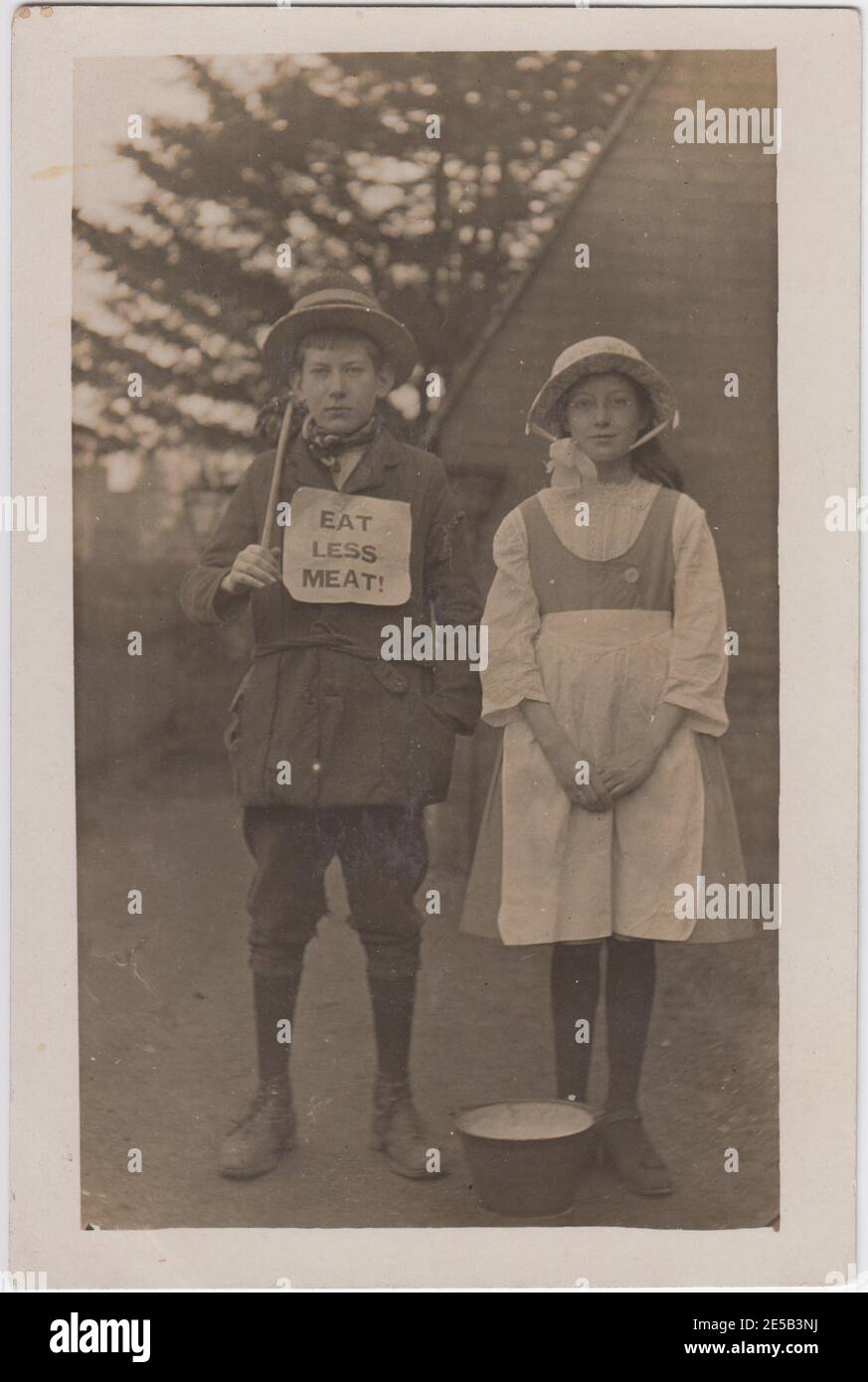 Photograph of two children, the boy has a sign saying Eat Less Meat on ...