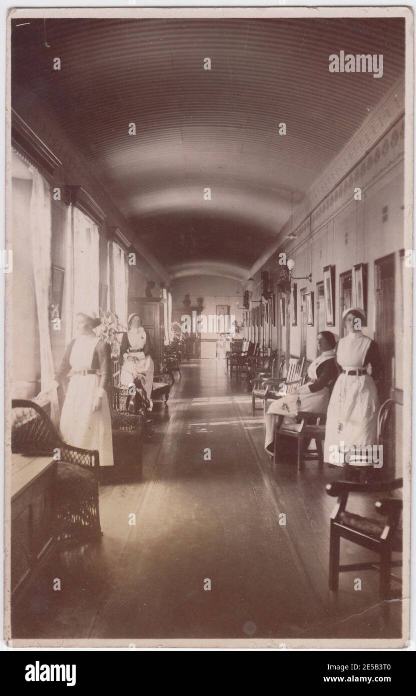 Nurses standing and seated in the corridor of a First World War ...