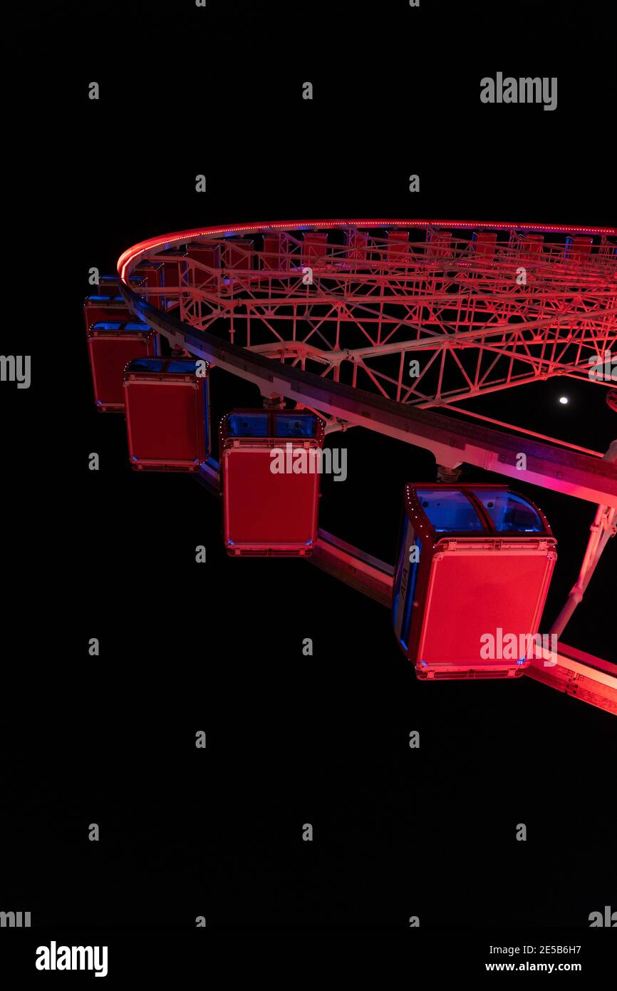 Ferris wheel of fair and amusement park. White clouds in the blue sky ...