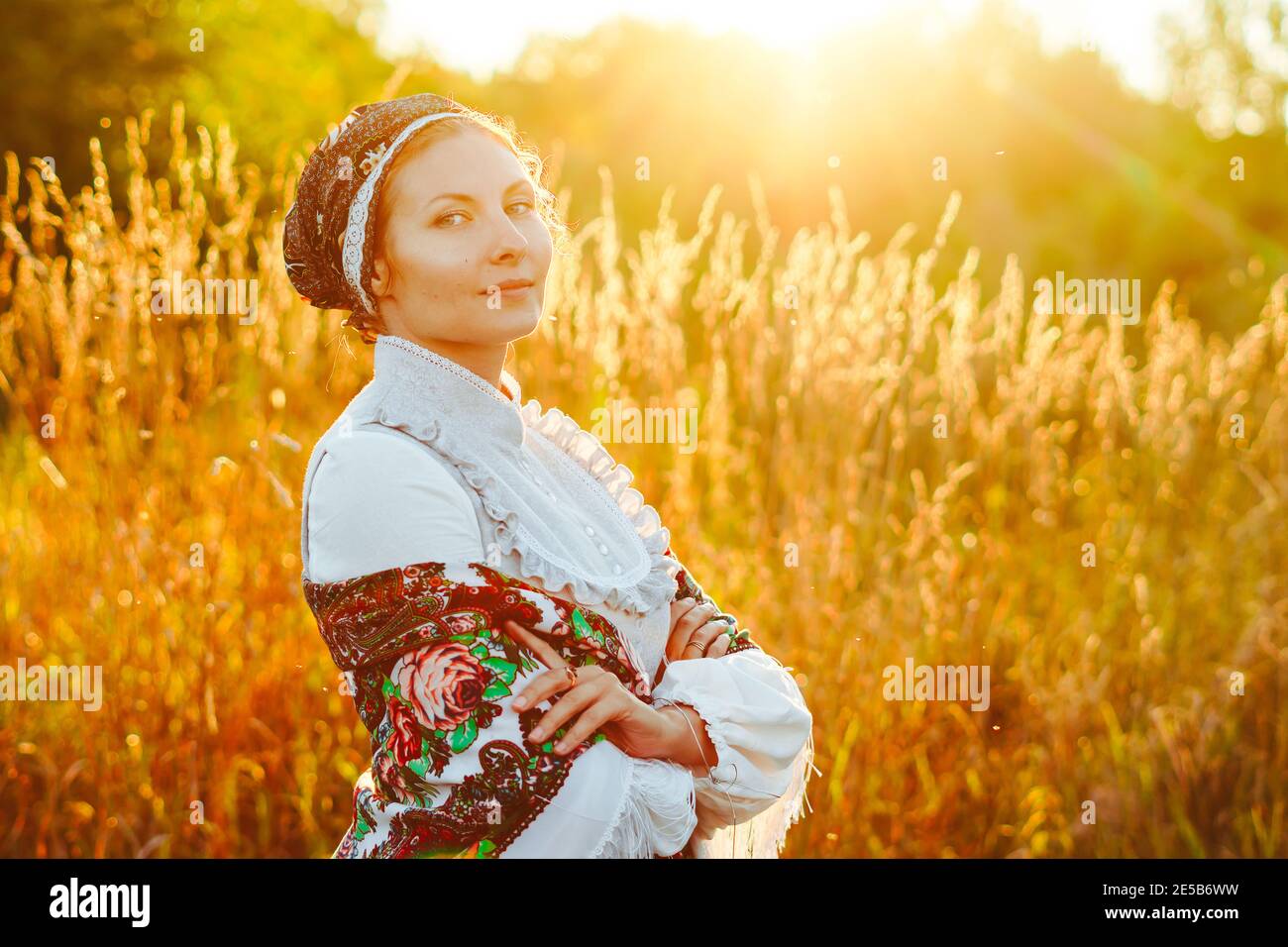 Young beautiful slovak woman in traditional costume on summer daisy ...