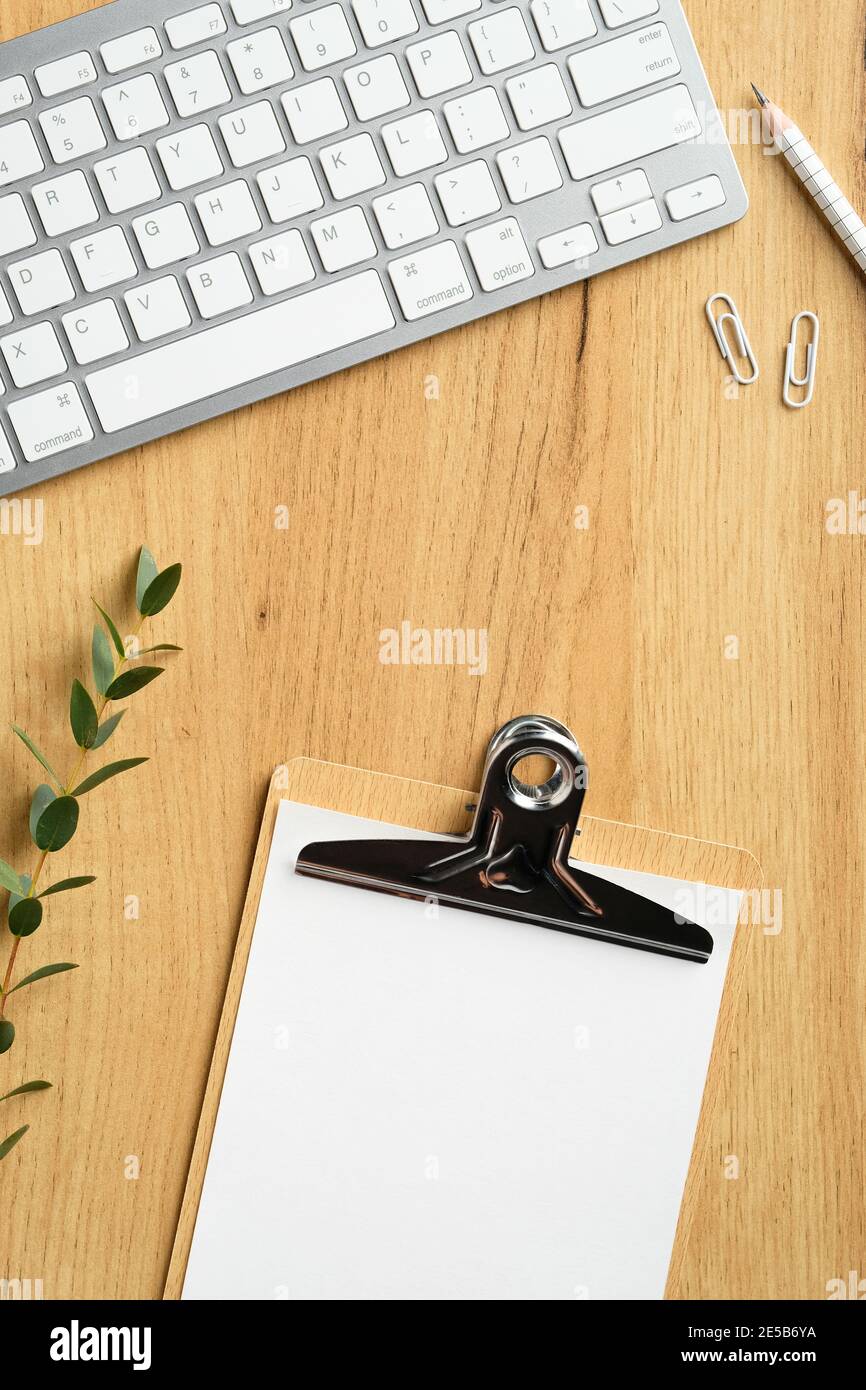 Modern wood office desk table with keyboard, clipboard, office supplies ...