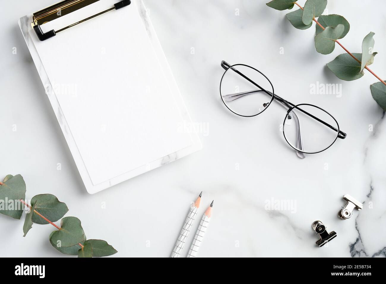 Elegant feminine home office desk with paper clipboard, glasses ...