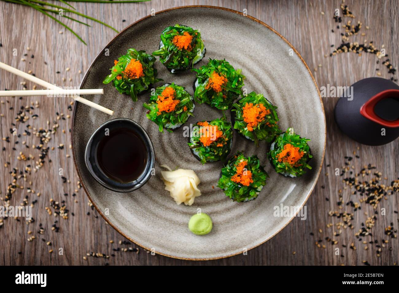 Sushi maki rolls with crab, seaweed salad and flying fish roe on a ...