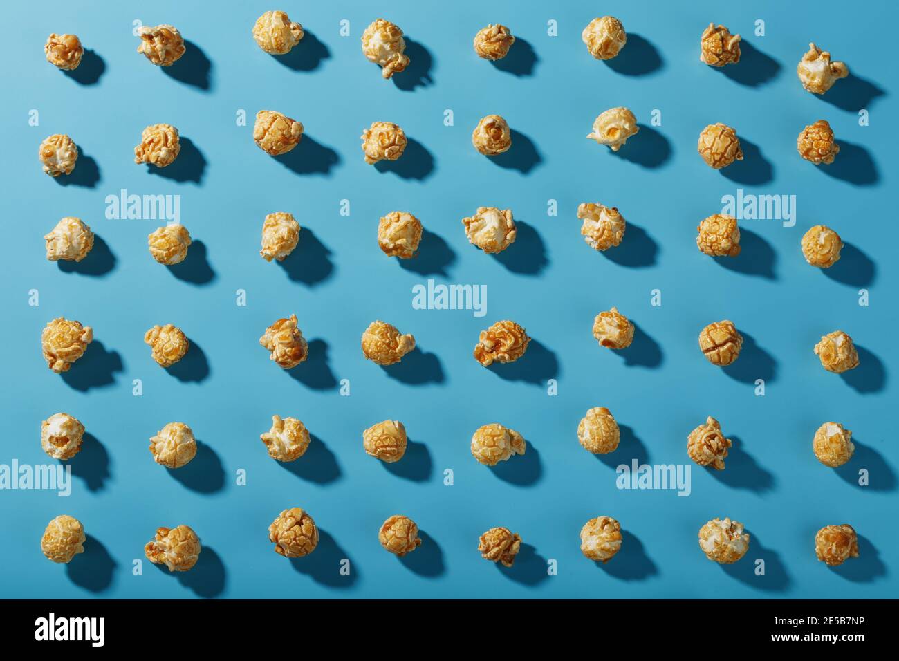 A pattern of popcorn patterns on a blue background. Full screen as a ...