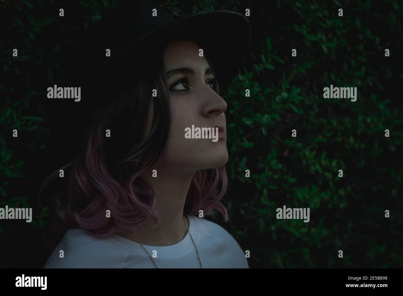 Closeup of a young Caucasian hipster girl with purple hair wearing a ...