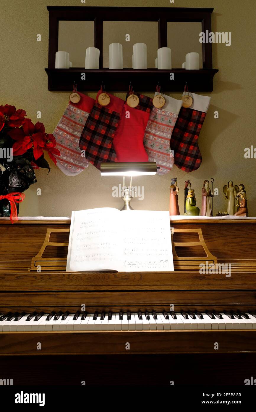Christmas decorations on piano with music and hanging stockings Stock ...