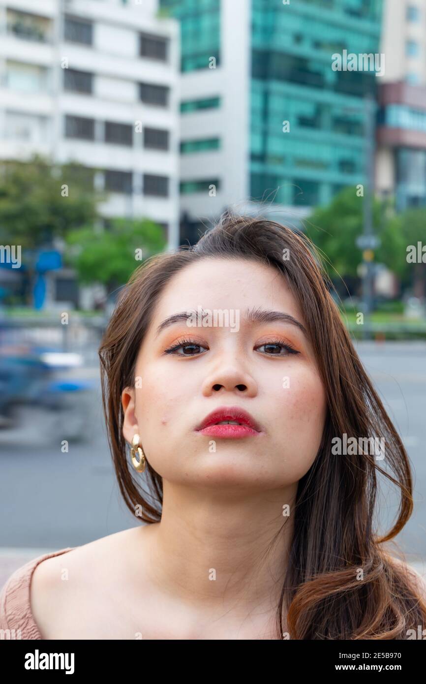 Selective focus shot of an attractive Asian female posing in a city ...