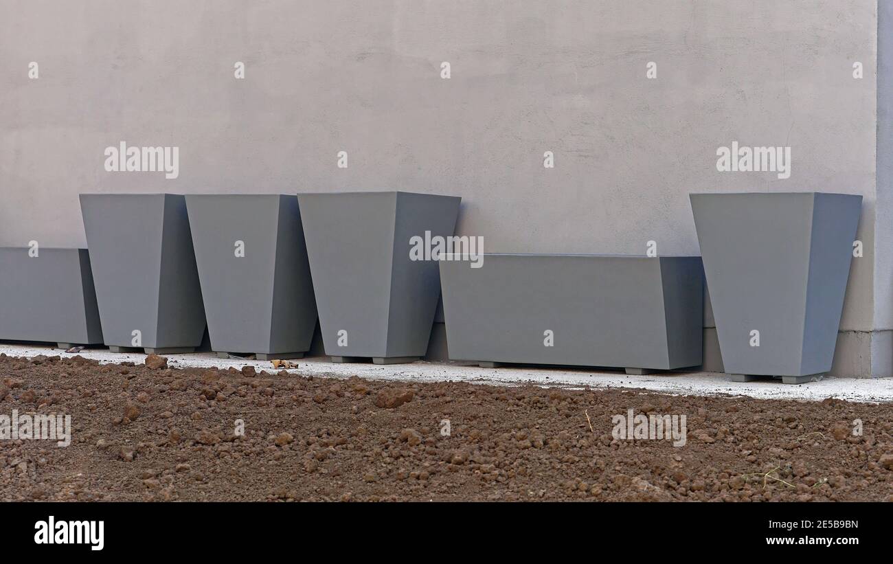 Modern shape grey pots for new garden Stock Photo - Alamy