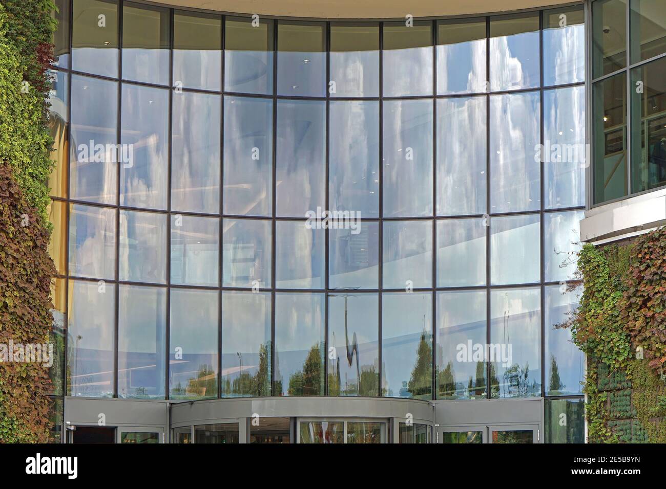 Big wall covered with many glass windows exterior Stock Photo - Alamy
