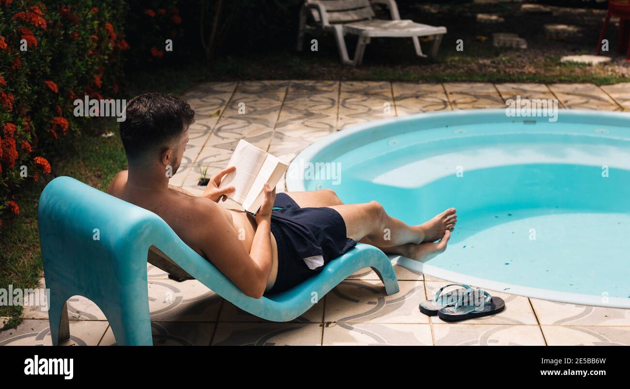 Person reading in pool hi-res stock photography and images - Alamy