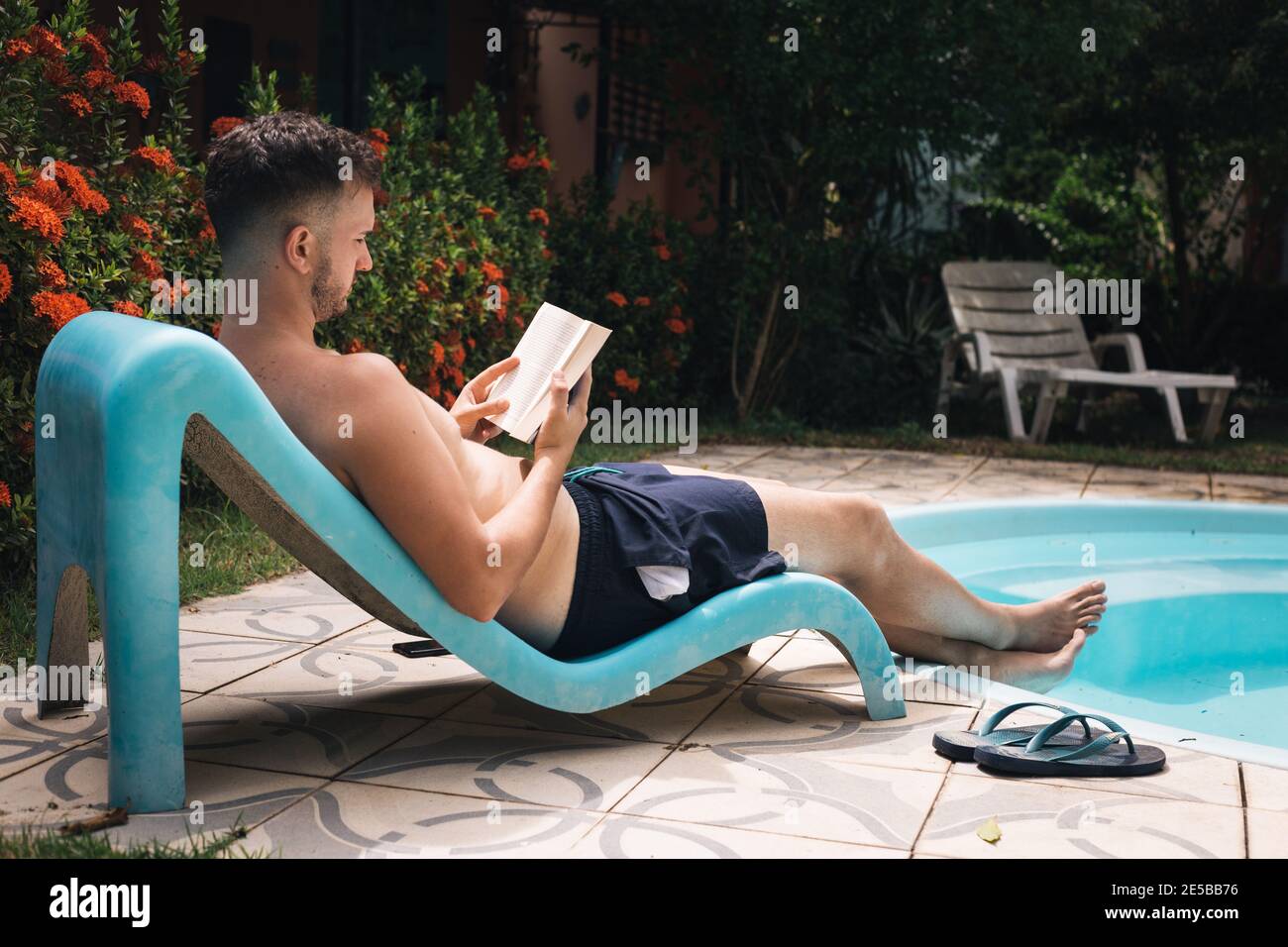 Woman reading book in swimming pool hi-res stock photography and images ...