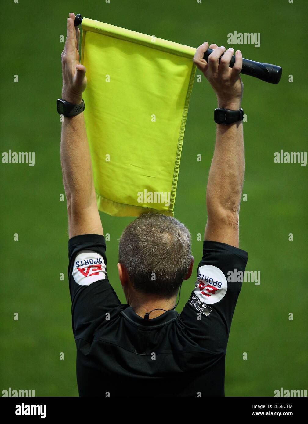 An official waves a flag Stock Photo - Alamy