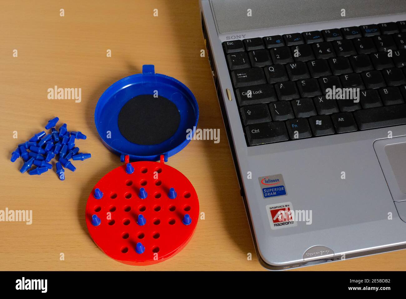 Solitaire game in bright blue and red plastic from above with no way of ...