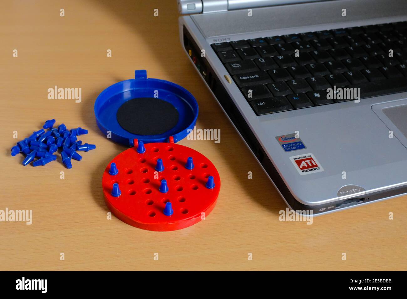 Solitaire game in bright blue and red plastic from above with no way of ...