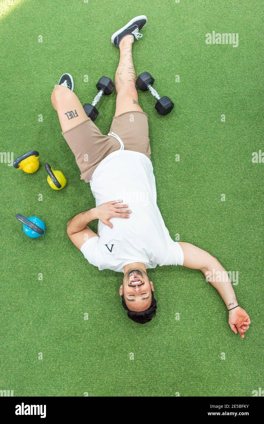 Young, strong, and handsome man happy after a great workout in the gym ...
