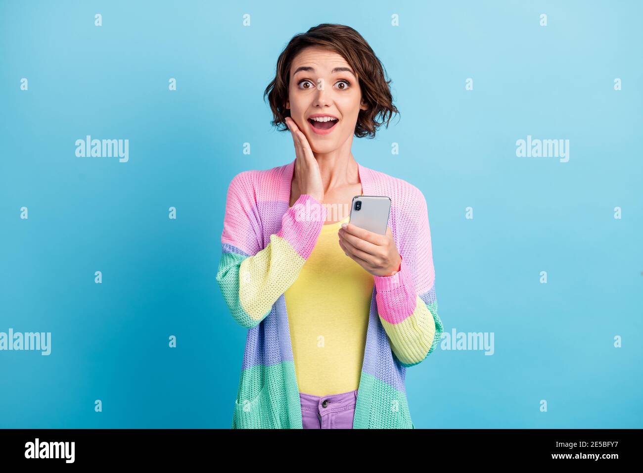 Photo portrait of shocked woman with open mouth touching face cheek ...
