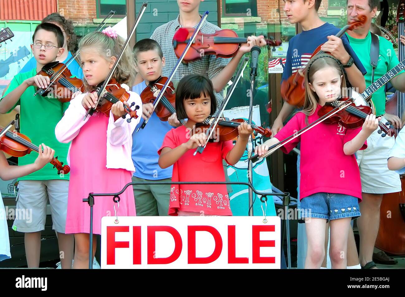 Violin strings group made up of children play a recital outside for the ...