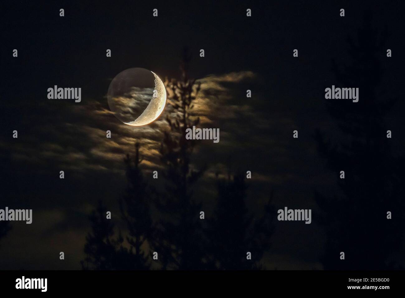 An amazing dramatic view of the Crescent Moon in between the clouds and ...