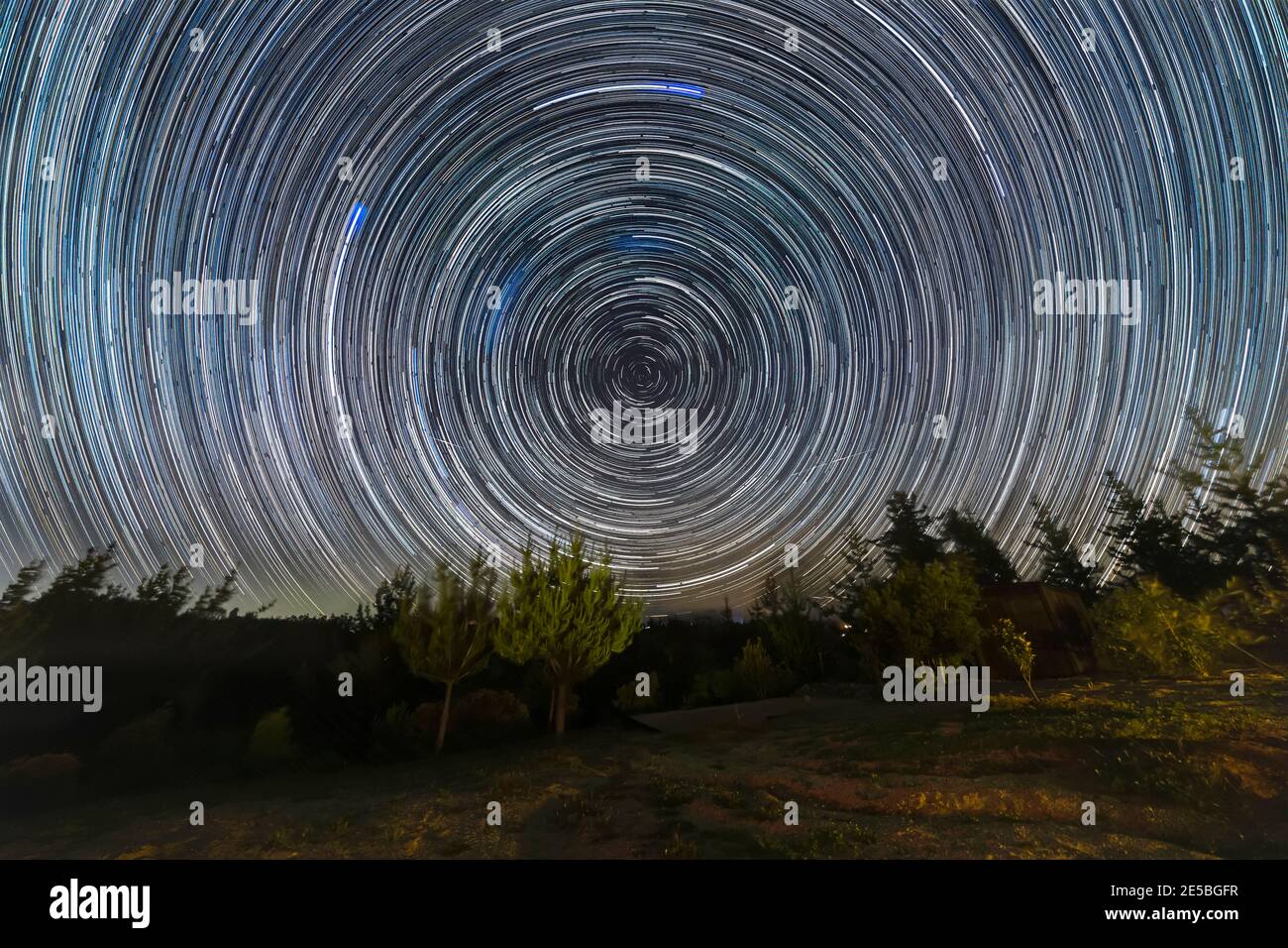 The Earth rotation as seen in the night sky with the star trails. An ...