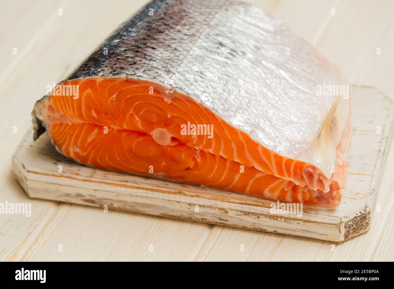 raw salmon on cutting board. Piece of fresh salmon on a white board ...