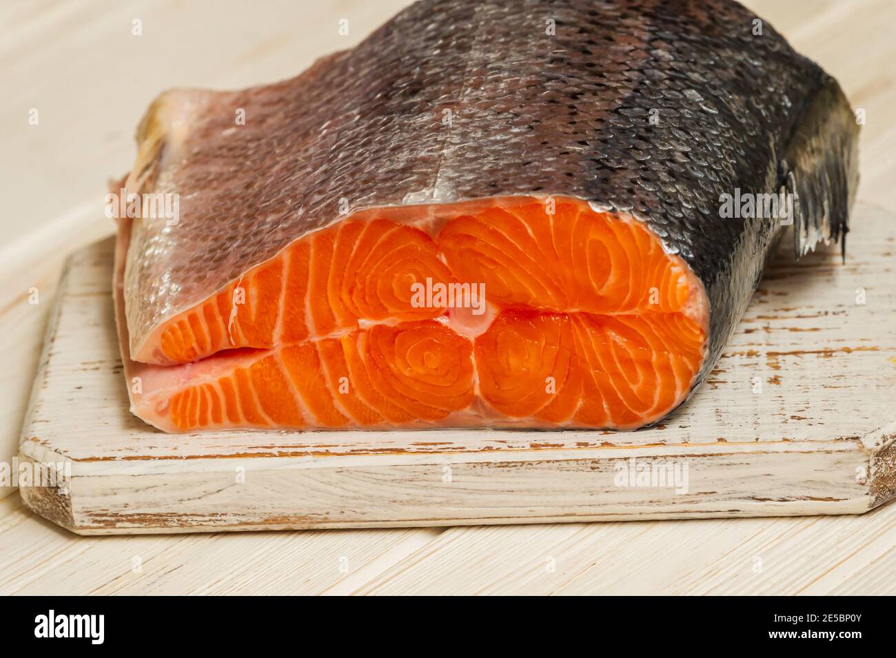 raw salmon on cutting board. Piece of fresh salmon on a white board ...