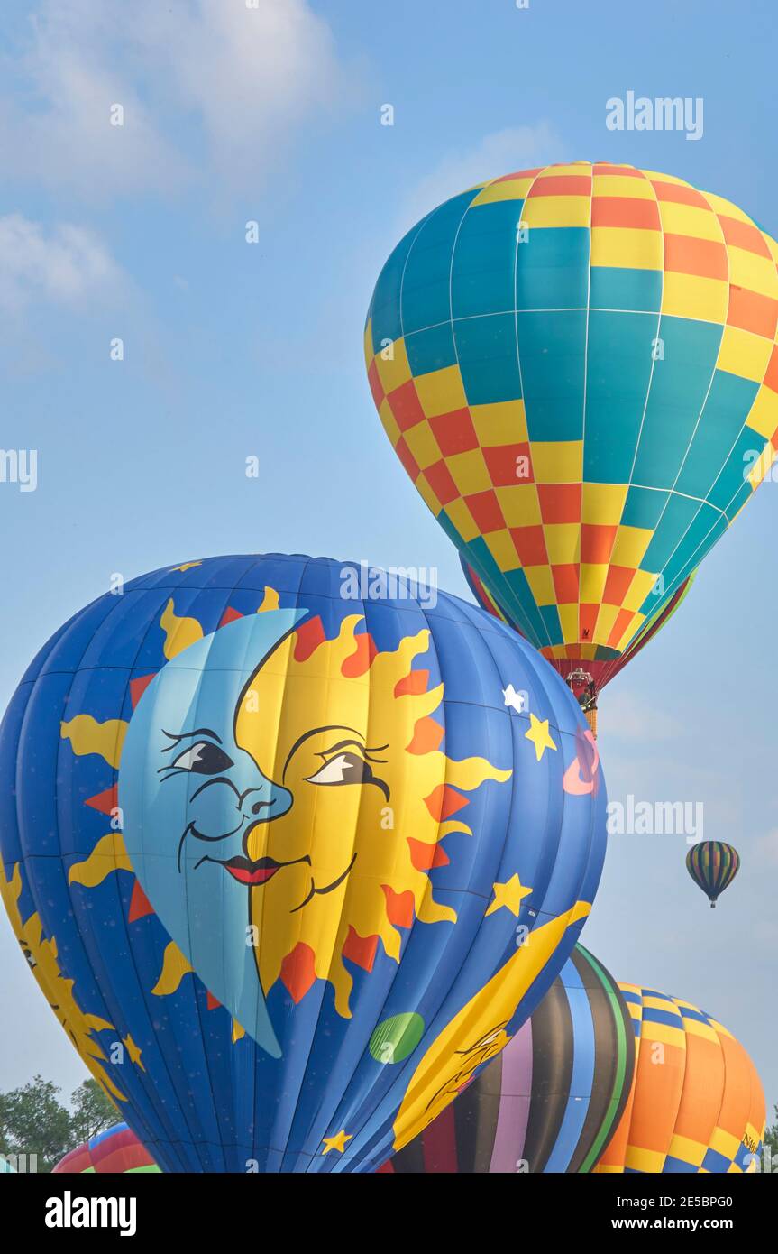 Hit Air Balloons in flight and inflating Stock Photo - Alamy