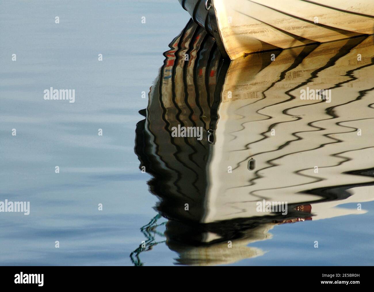 dangling boat reflection in harbor water Stock Photo - Alamy