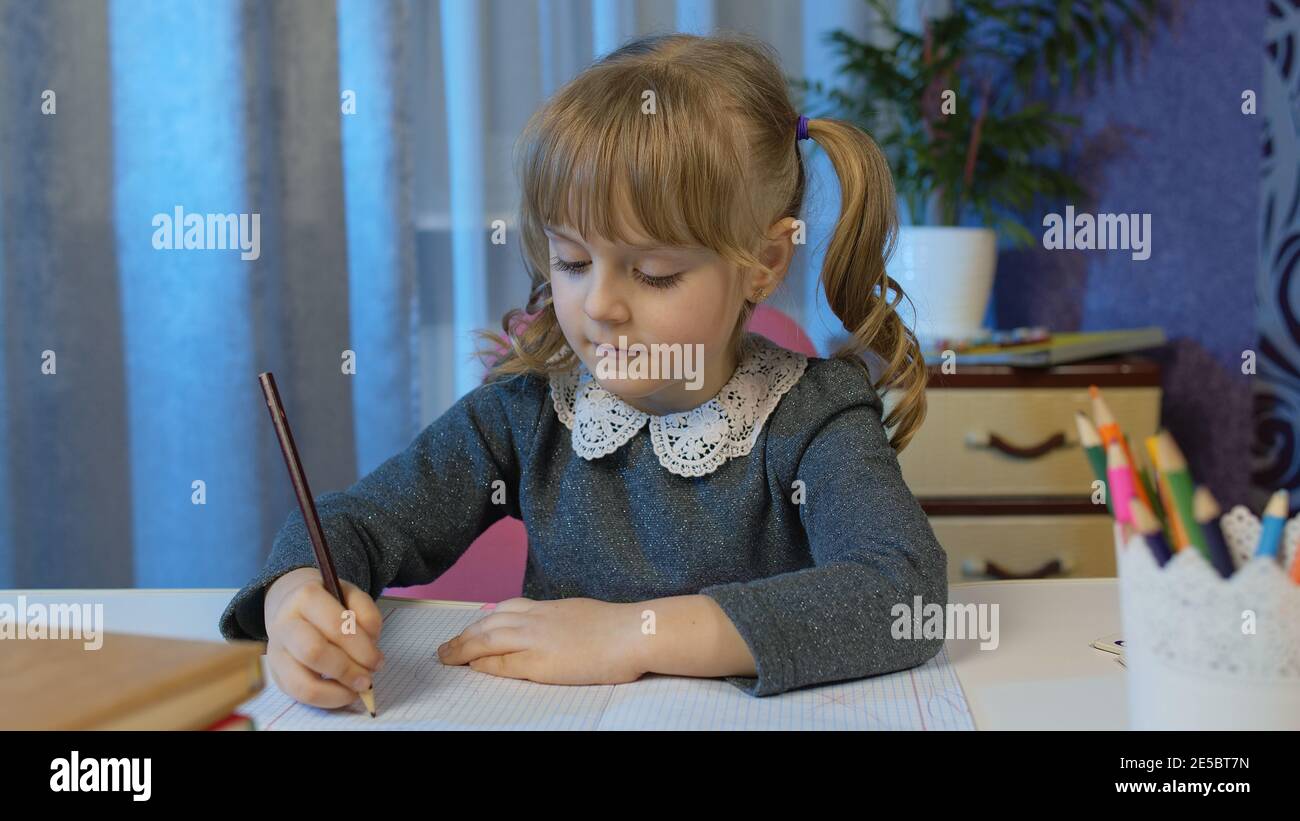 Child girl looking at web camera making video call learning, studying ...