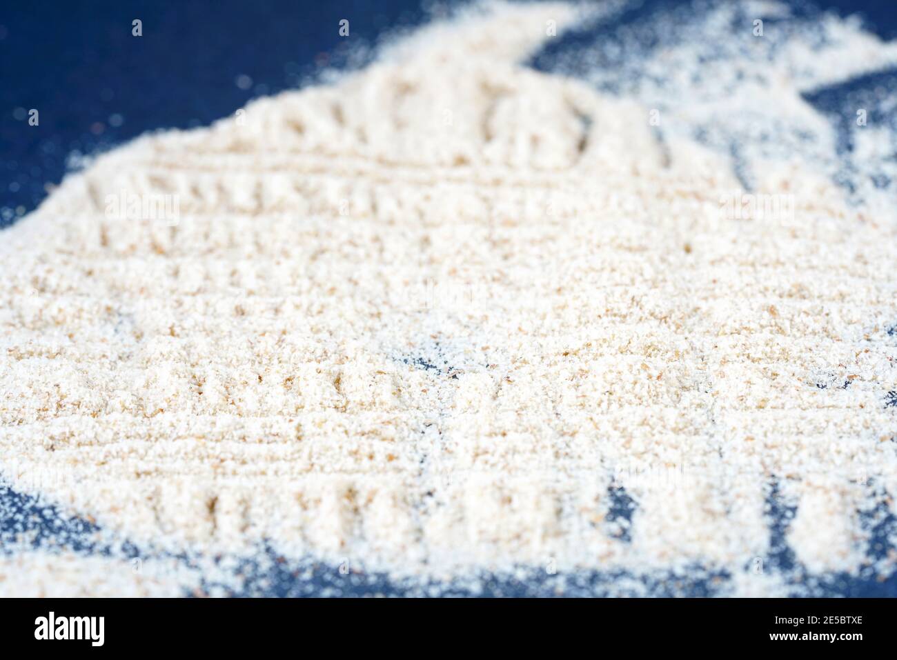 Ground Indian flea seeds photographed in the studio against a black ...