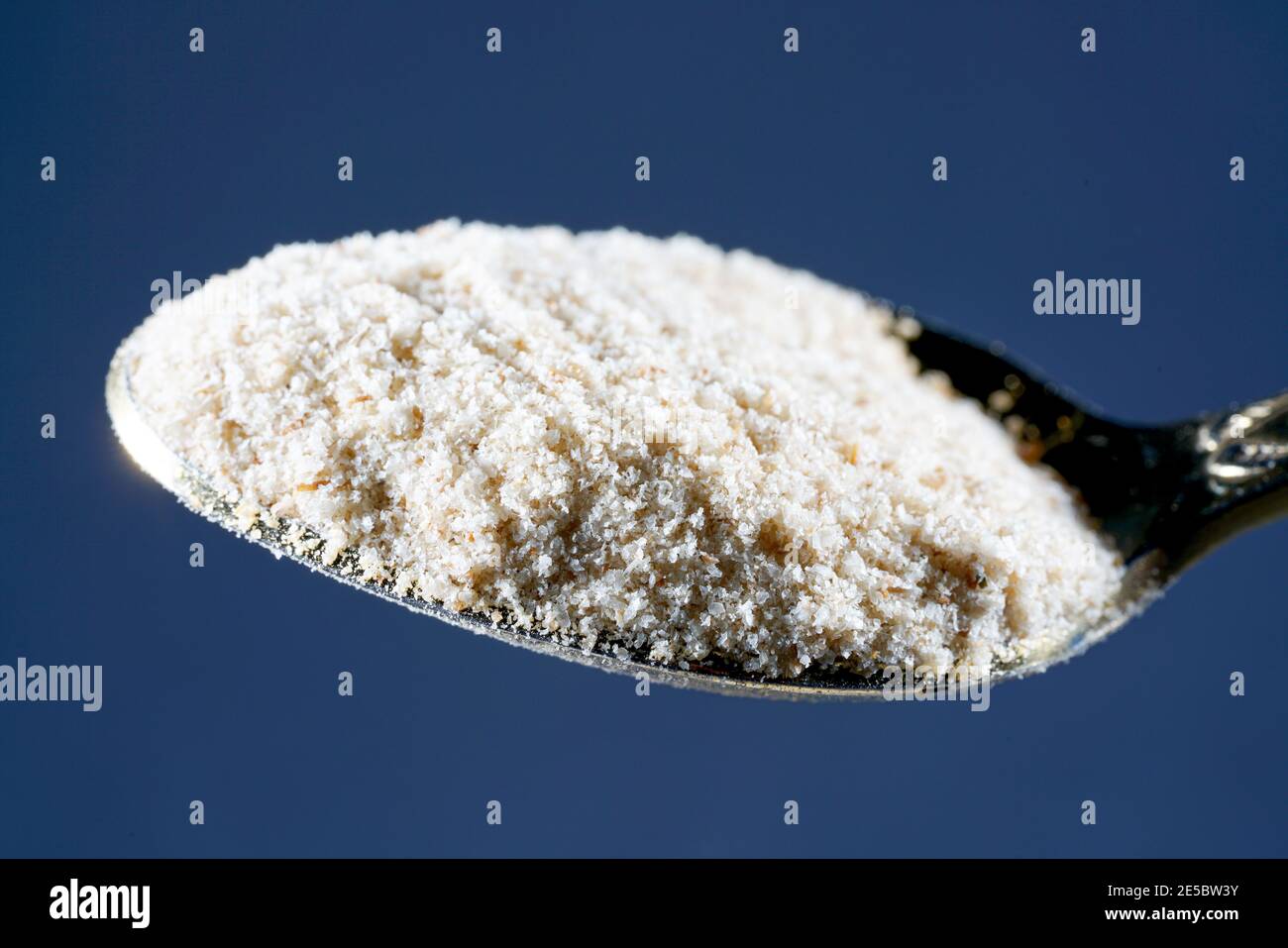 Ground Indian flea seeds photographed in the studio against a black ...