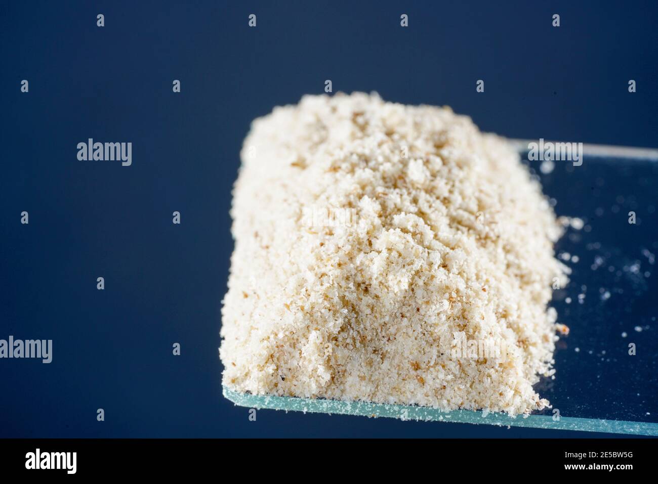 Ground Indian flea seeds photographed in the studio against a black ...