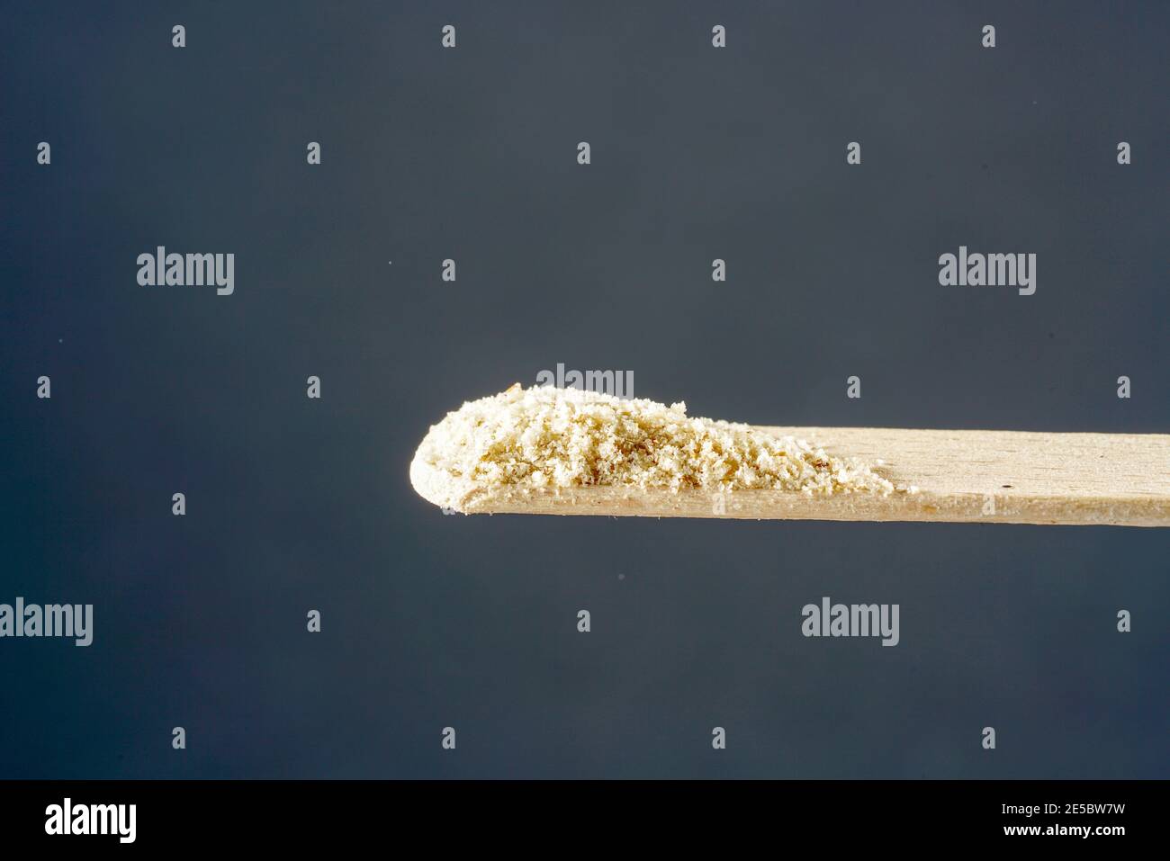 Ground Indian flea seeds photographed in the studio against a black ...