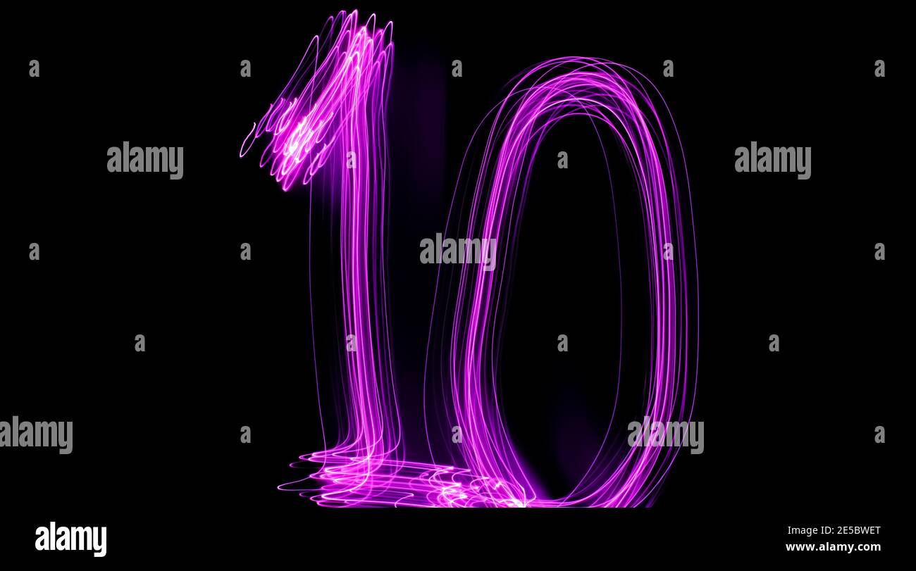 Long exposure photography. Writes 10 with pink light on black ...