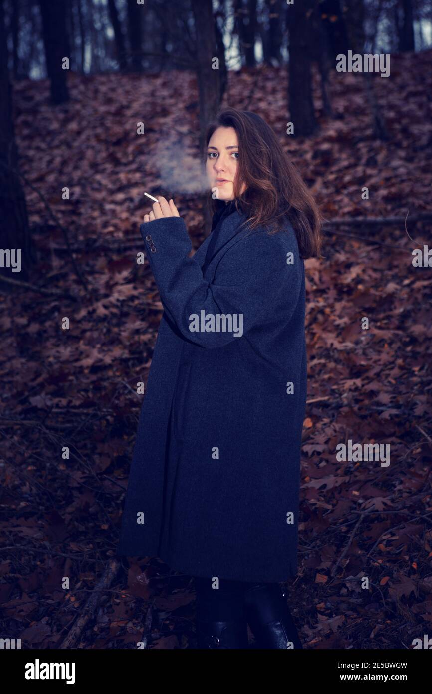 Brunette smoking cigarette hi-res stock photography and images - Alamy