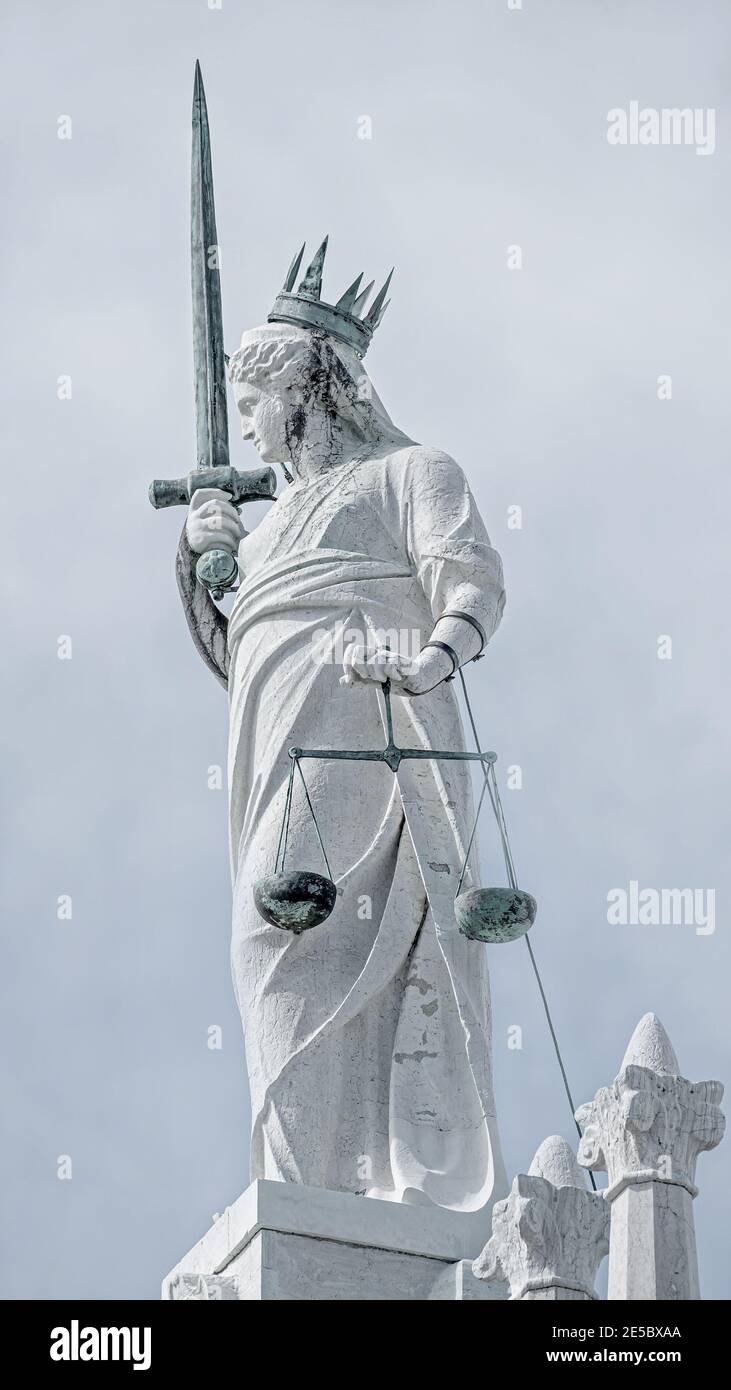 Ancient statue of goddess Justice with sword and scale at the roof top ...
