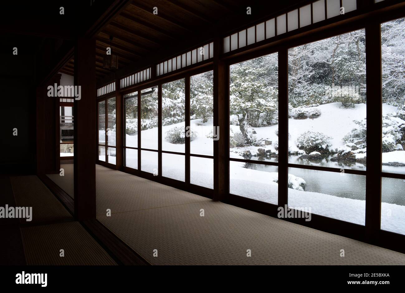 Traditional Japanese style room with a view over snowy winter landscape ...
