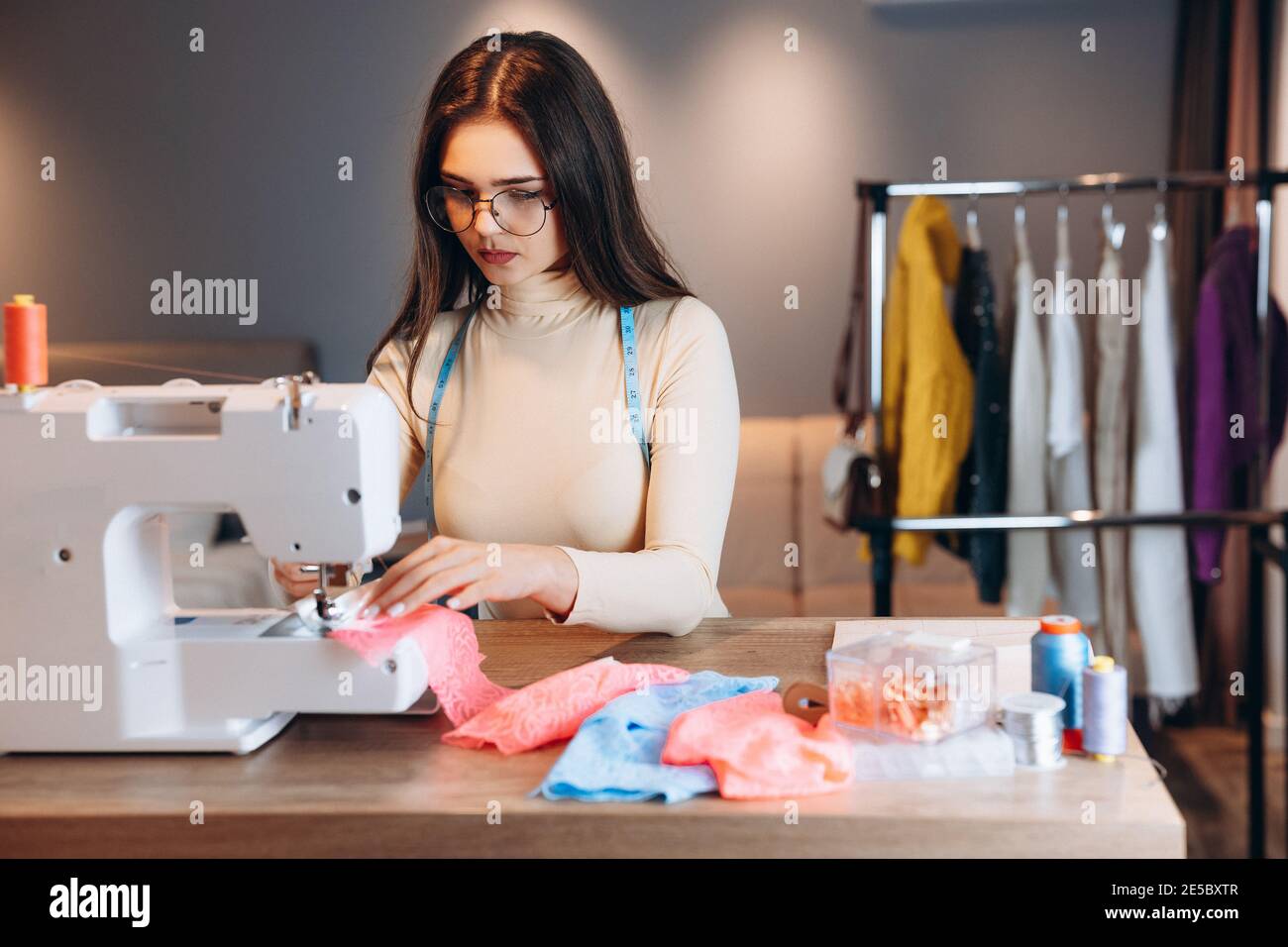 Pretty dressmaker woman sews hi-res stock photography and images - Alamy