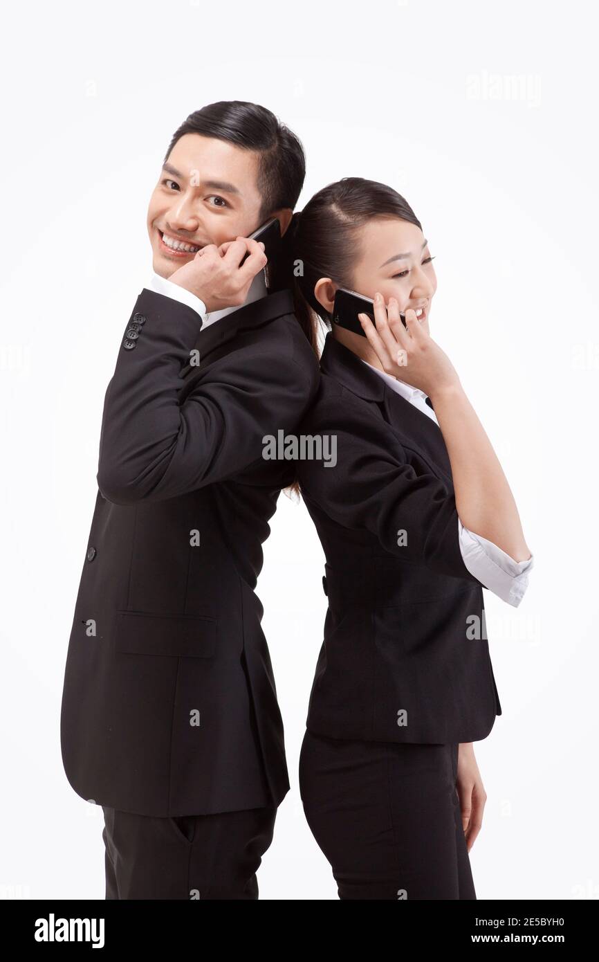Young business man and woman back-to-back telephone high quality photo ...