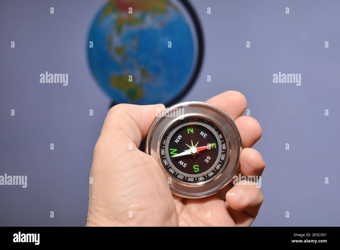 Compass in hand. Navigation on the terrain using a magnetic compass ...