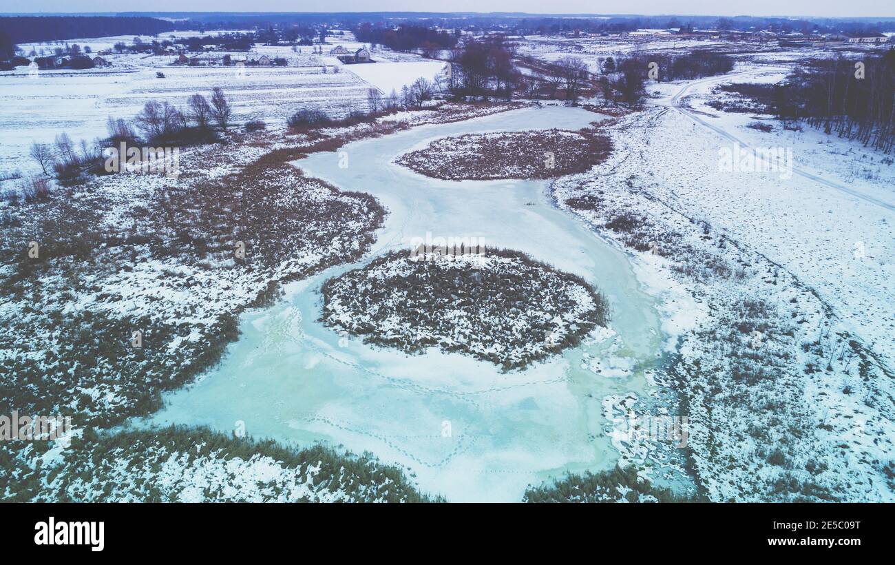 Aerial view of the frozen brook in winter. The texture of icy creek ...