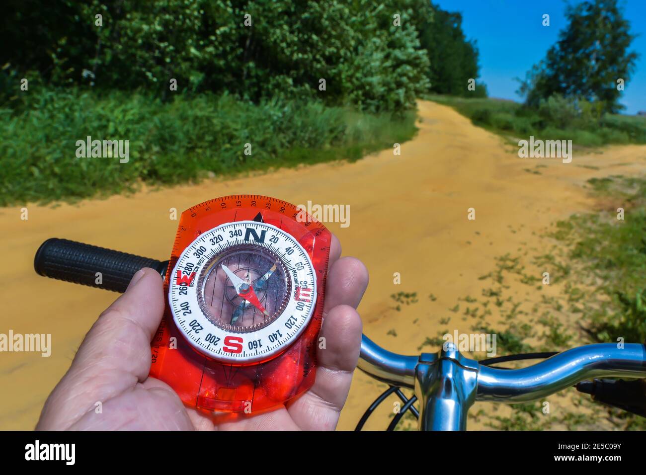 Compass in hand. Navigation on the terrain using a magnetic compass ...