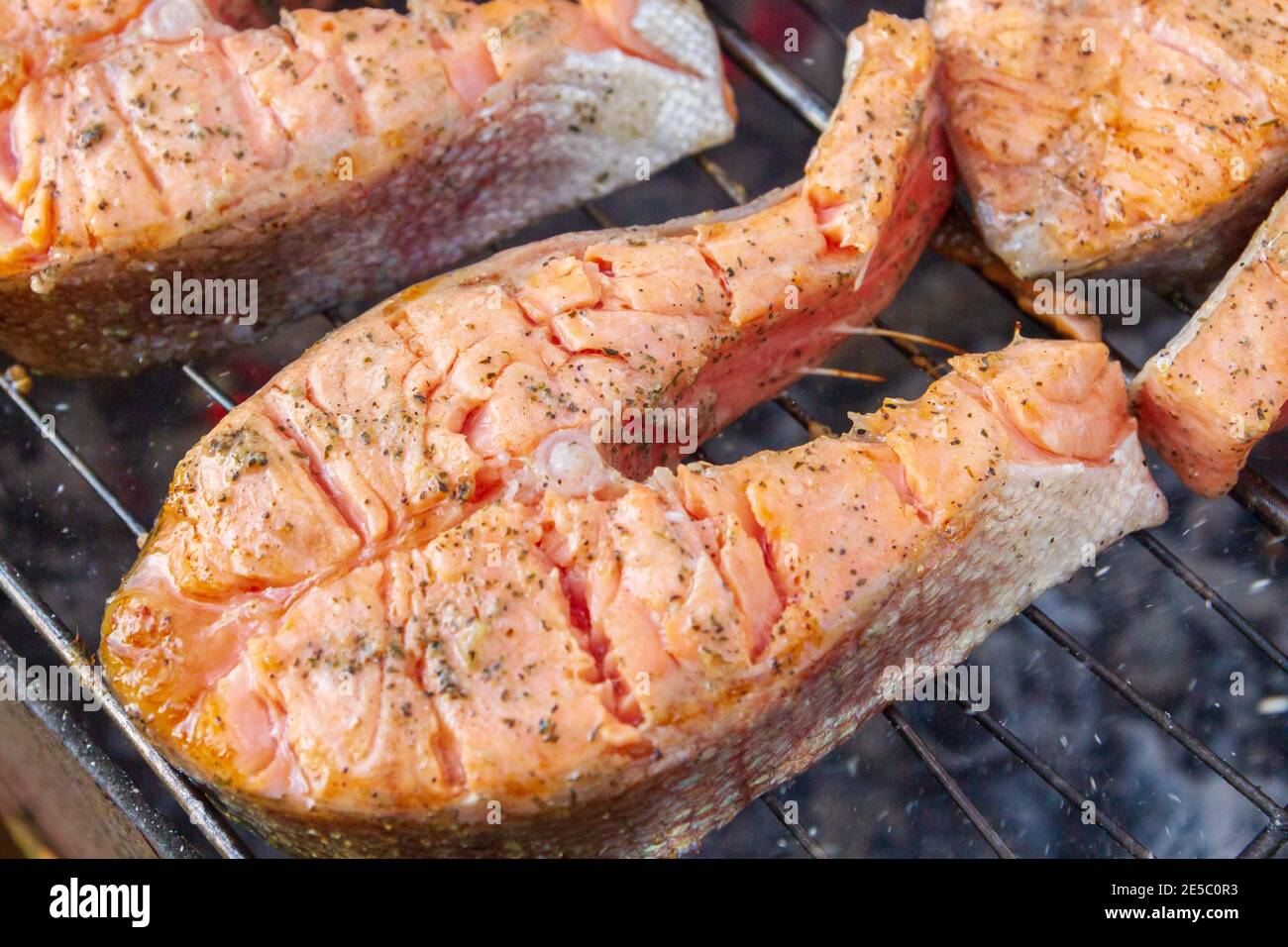 Large fish steaks fresh trout fried in spices on the grill Stock Photo ...