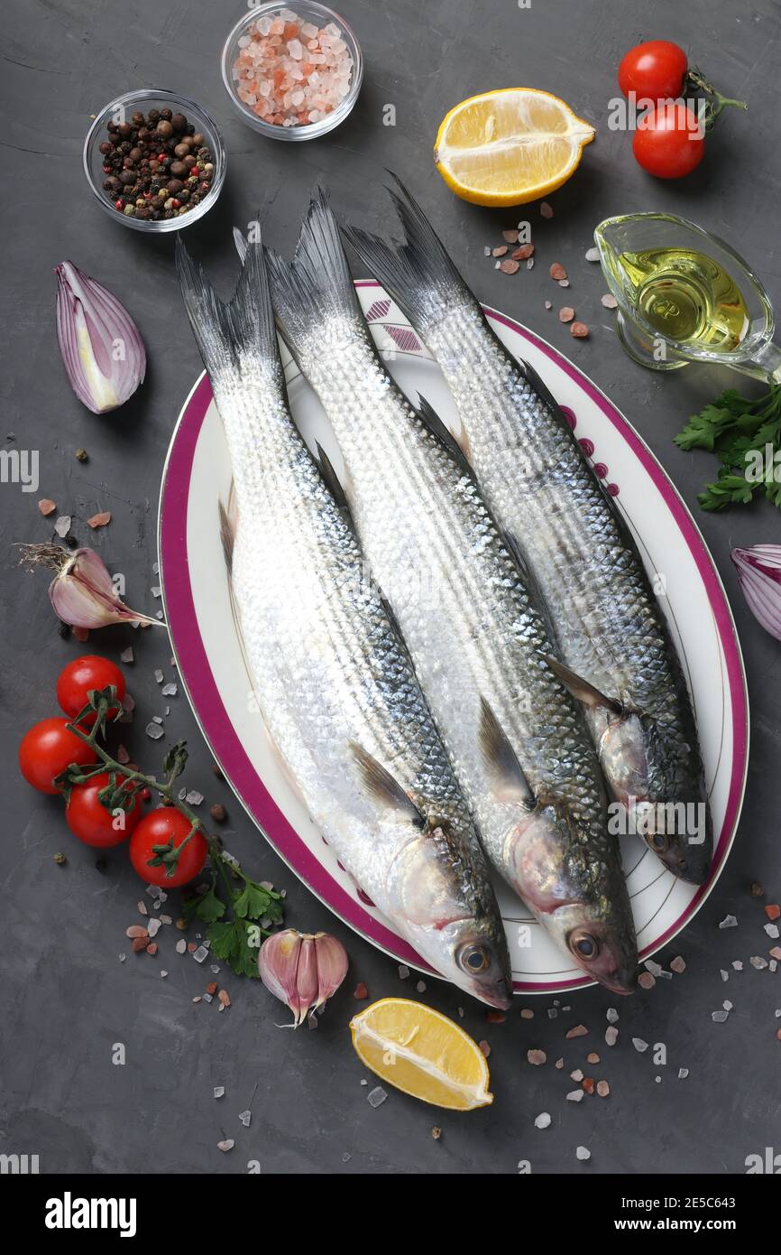 Fresh ready to cook raw mullets with ingredients and seasonings like ...