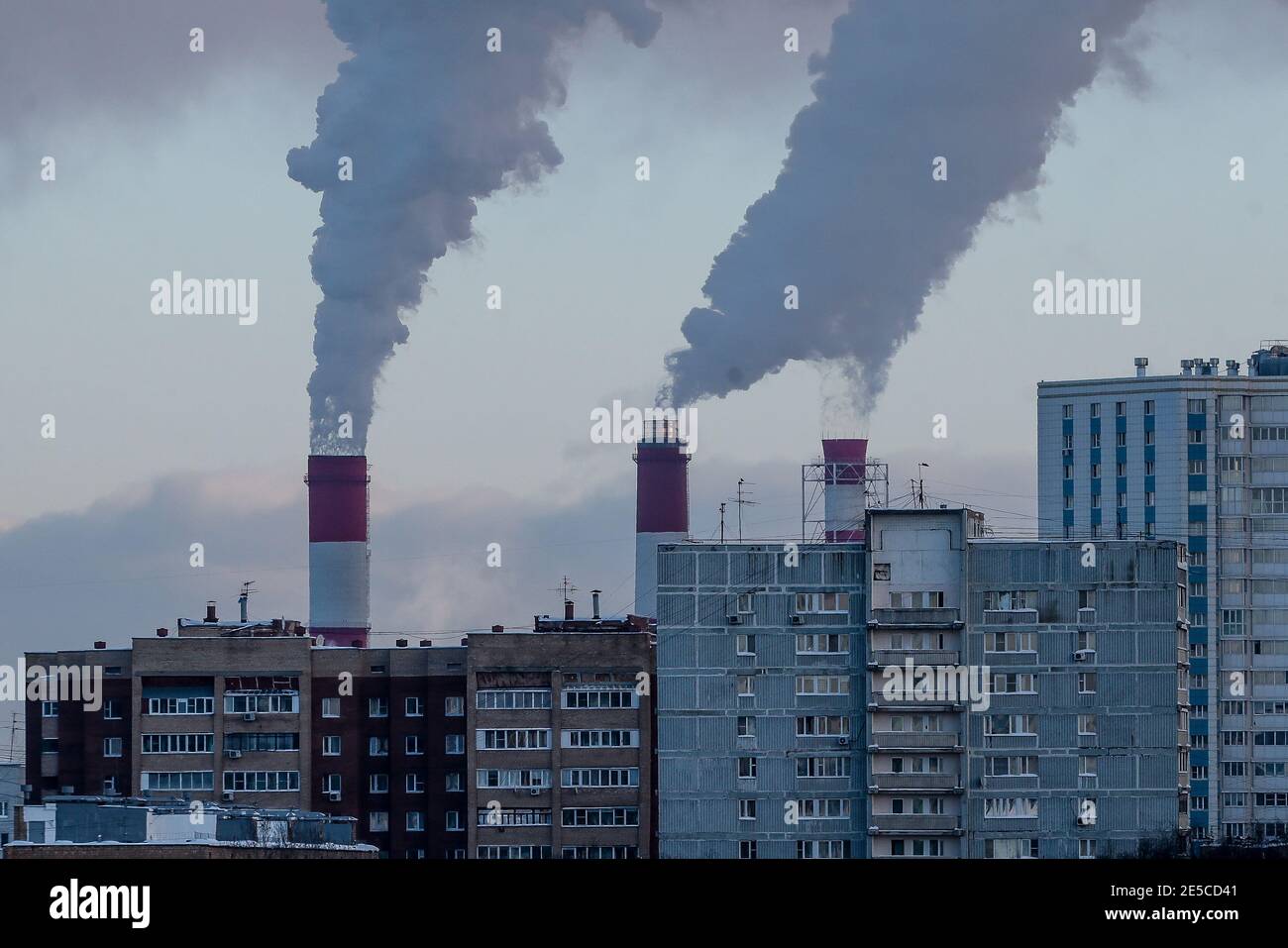 Russia, Moscow. Steam rises from cooling towers of a combined heat and ...