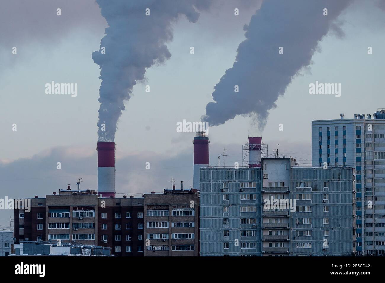 Russia, Moscow. Steam rises from cooling towers of a combined heat and ...