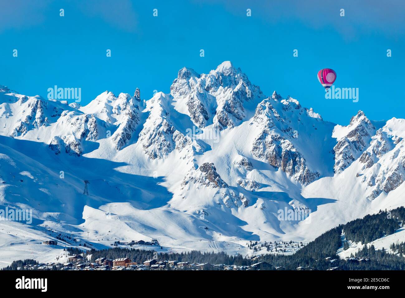 Vivid red colorful hot air balloon over Courchevel valley in French ...